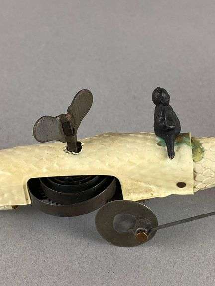 Vintage Celluloid Man on Snake Wind-Up Toy - Matthew Bullock Auctioneers