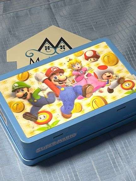 Mario metal box with lots of Pokémon cards - McNatt Real Estate