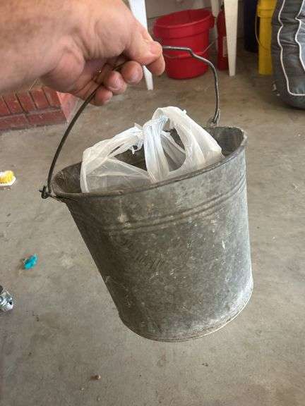 Galvanized bucket with privacy fence hardware - McNatt Real Estate