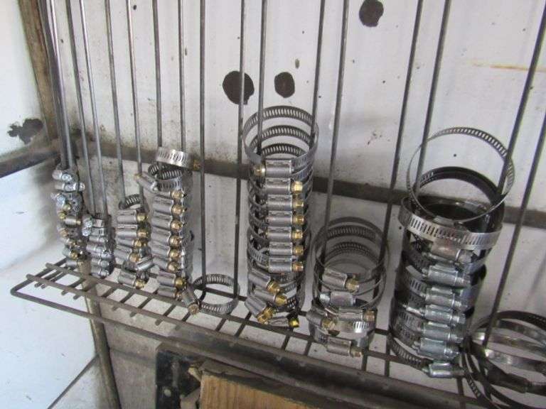 HOSE CLAMP RACK WITH NEW HOSE CLAMPS - McPherson Auction & Realty