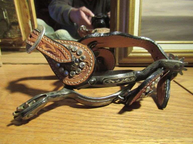 pair of black engraved spurs with leather straps - McPherson Auction ...