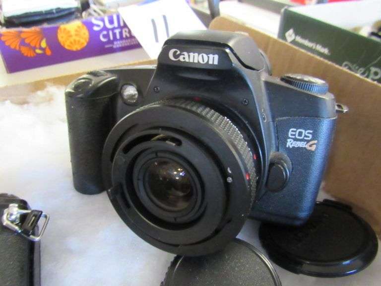 TWO CANNON CAMERAS, THREE LENSES AND THREE CAPS. - McPherson Auction ...