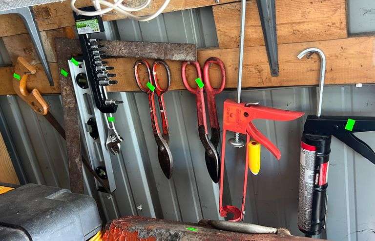 Tool assortment on wall, adjustable wrench, socket drivers, tinsnips ...