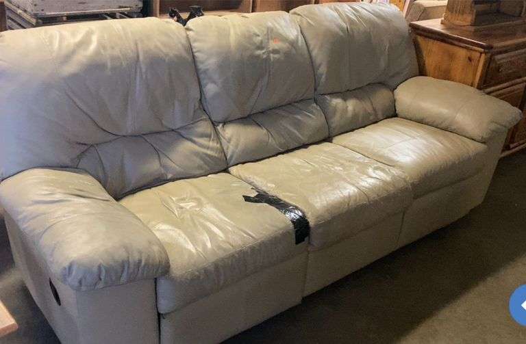 Tan couch, damaged rip in cushion 8 FT L - Metzger Property Services, LLC