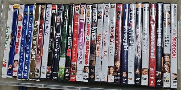 DVD assortment in plastic tote - Metzger Property Services, LLC