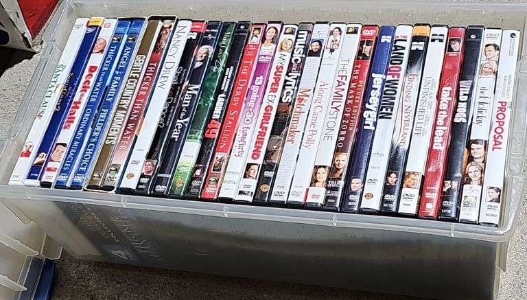 DVD assortment in plastic tote - Metzger Property Services, LLC