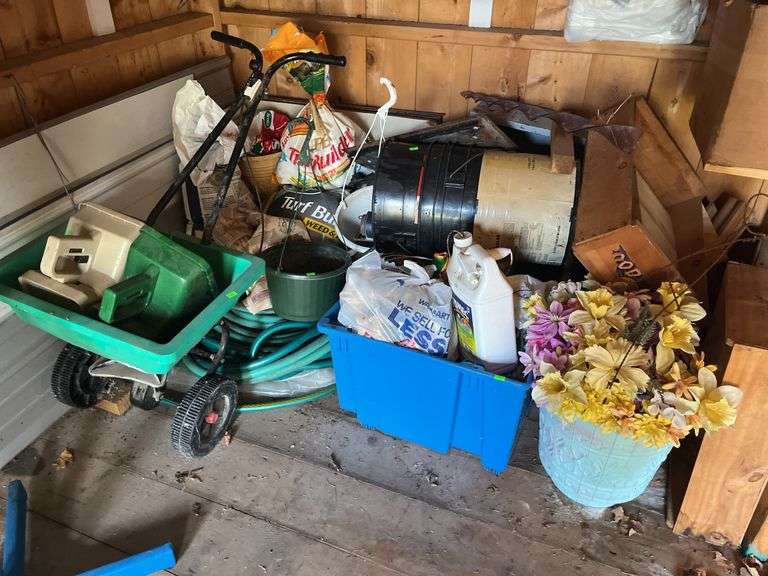 Lawn spreaders, garden hose, partial lawn fertilizer, Misc contents as ...