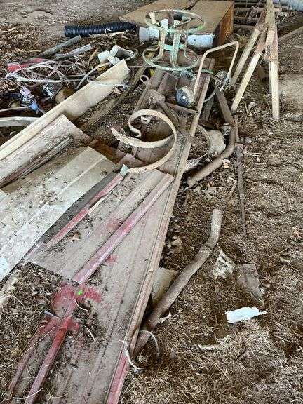 Scrap pile including spike tooth harrow parts and drag as shown in ...