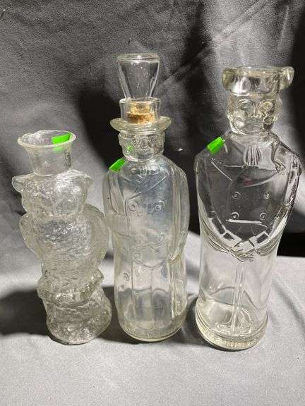 Three Clear Glass Bottles with Figural Designs - Metzger Property ...