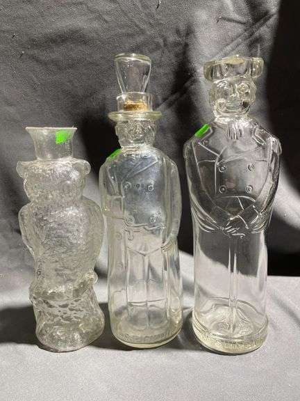 Three Clear Glass Bottles with Figural Designs - Metzger Property ...