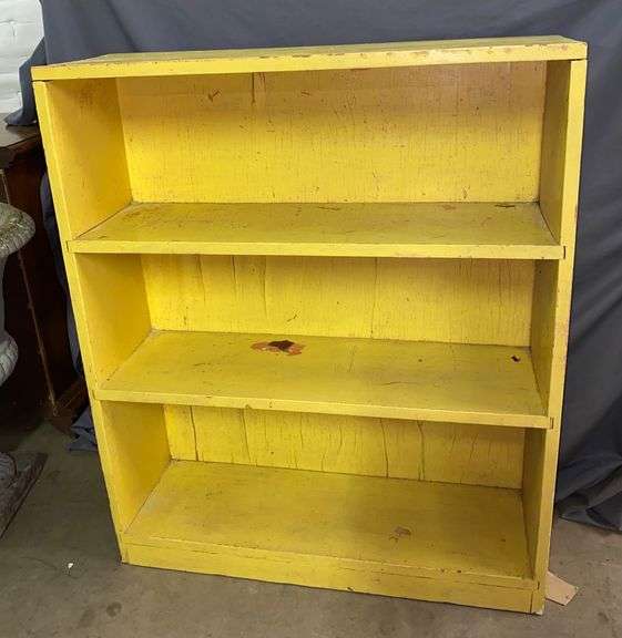 Yellow Painted Wood Bookshelf - Metzger Property Services, LLC