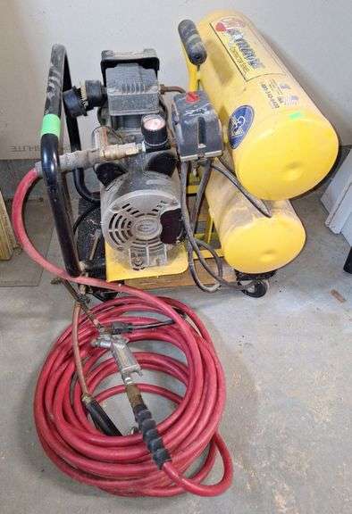 Extreme contractor series 4 gallon air compressor with hose on 4 wheel ...