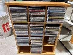 CD Storage Unit with Assorted Music CDs - Metzger Property Services, LLC