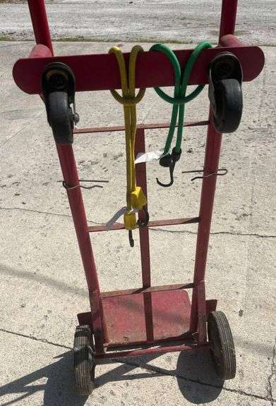 Red Metal Hand Truck with Bungee Cords - Metzger Property Services, LLC
