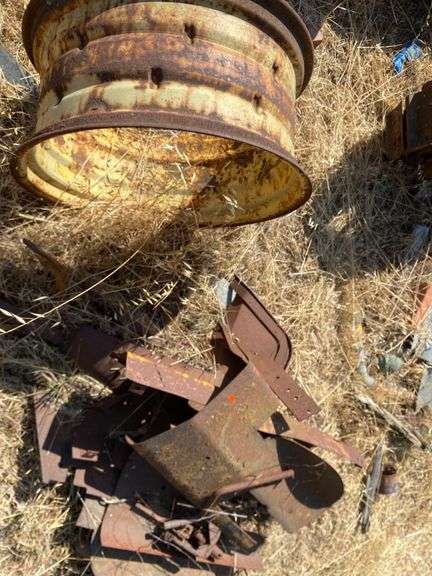 Rusted Metal Objects and Tractor Wheel Rim - Metzger Property Services, LLC