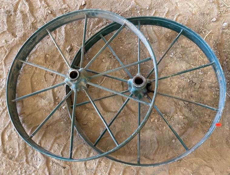 Cast Metal Spoked Wheels With Green Finish - Metzger Property Services, LLC
