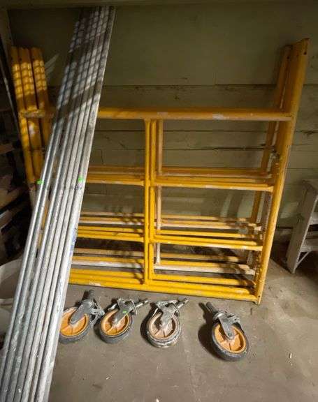 Yellow Metal Scaffolding Frames with Casters and Support Braces ...