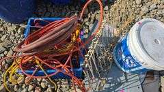 Extension Cords, Wire Holders, Metal Panels, and Plastic Bucket with ...