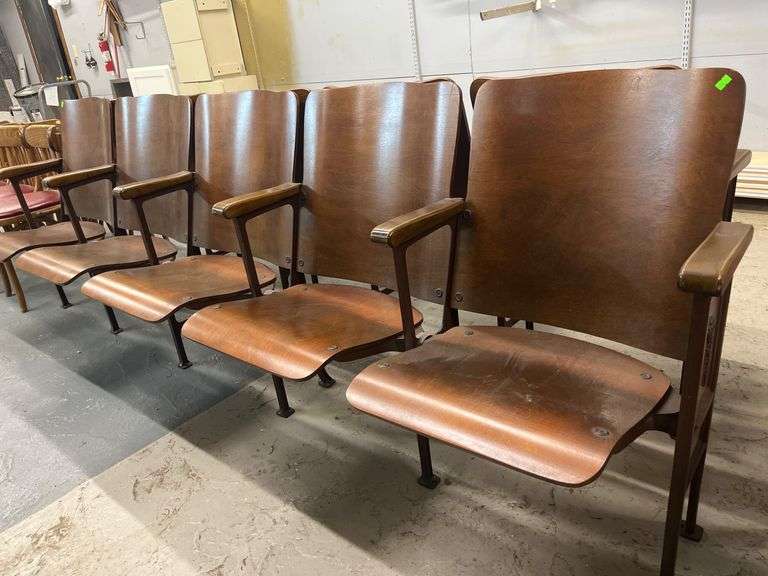Row of Connected Auditorium-Style Seats with Wood Frames and Metal Arms ...