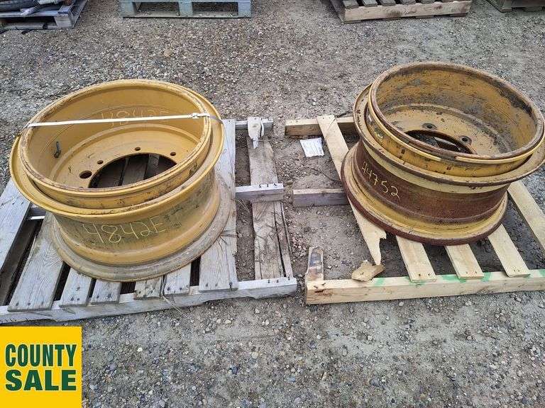 2 CAT Rear Backhoe Rims - Michener Allen Auctioneering Ltd