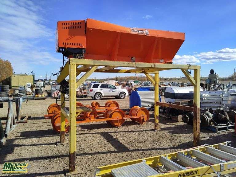 SaltDogg Hopper/Spreader on Steel Rack - Michener Allen Auctioneering Ltd