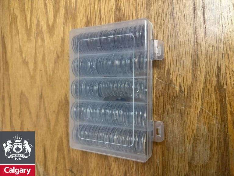 Clear container with various sealed collector coins - Michener Allen ...