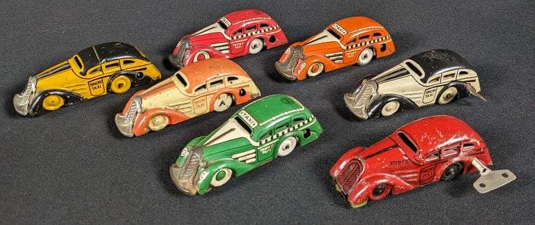 SET OF 7 TIN MARX TRICKY TAXI WIND UP TOYS - Millers Auction Co.