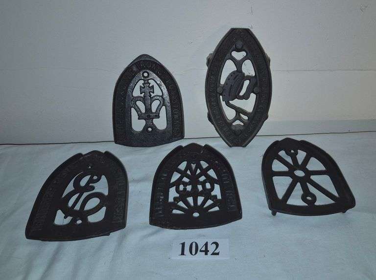 5 sad iron trivets - Mark Van Hook, Auctioneer