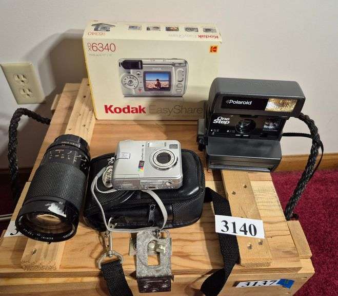 Two Kodak digital cameras, Polaroid camera, 35 mm SLR lens - Mark Van ...
