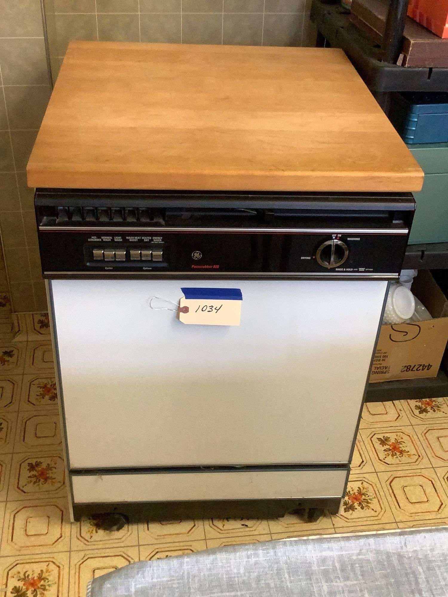 GE Portable dishwasher with butcher block top. Measures approximately 25 w x 27 d x 36 t. Worked when tested. Northern Kentucky Auction LLC