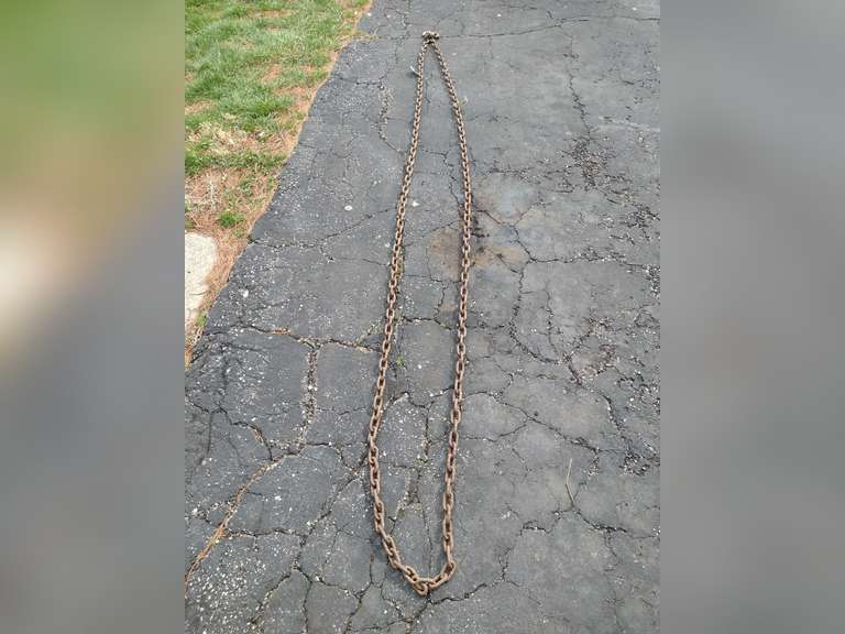20' 5/16" chain with hooks. 2 Short chains and hooks in 5-gallon bucket ...