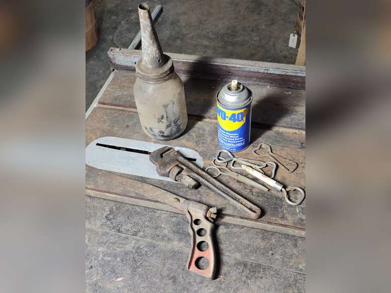 Old jar with oil spigot, Piper wrench, saw, bottle openers and the ...
