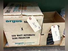 Argus 500 Watt Automatic Slide Projector and accessories. Powered on ...