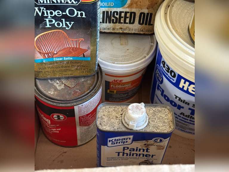 Box with unopened canned of roof sealant, wind seed, oil, stain, paint ...