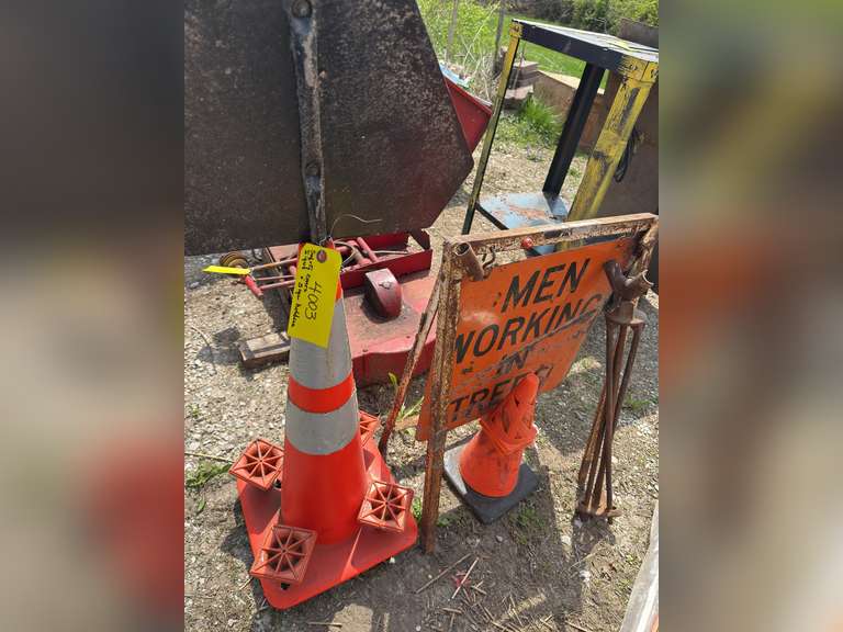 Two safety cones, "Men Working In Trees" sign in an A-frame and a farm ...