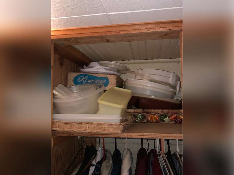 Contents of doubledoor closet with two drawers below (Wok, Tupperware ...