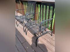 2 spring-loaded rocking black metal patio chairs - Parrott Marketing Group