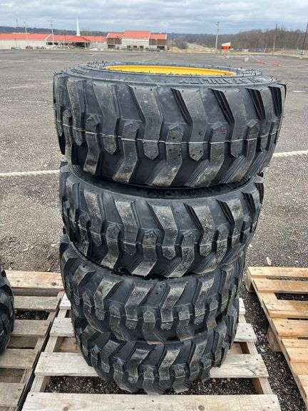 (4) Unused 12-16.5 Tires on Wheels For NH/JD/CA - RES Auction Services