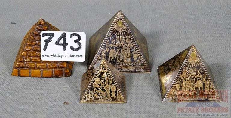 4 assorted small metal pyramids. Some with detailed etched decoration ...