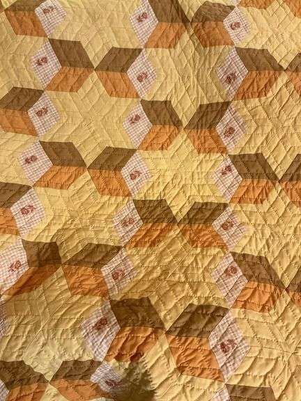 Hand stitched quilt in earth tones. - SCHULTIS & SON, INC.