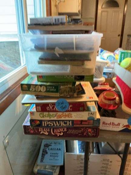 Stack of games, puzzles, and books - SCHULTIS & SON, INC.