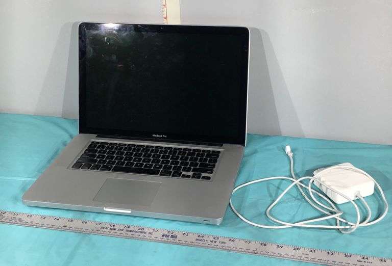 MacBook Pro w/ Charger, Has Power - Sherwood Auctions
