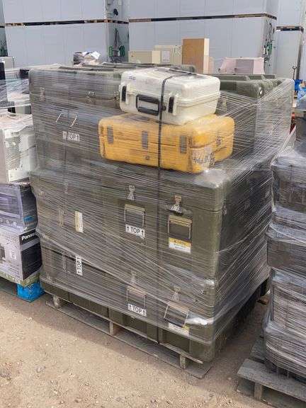 Approximately eight military style hard plastic cargo containers ...