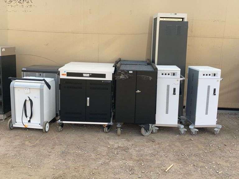 Approximately eight assorted computer charging carts and server tower ...