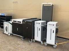 Approximately eight assorted computer charging carts and server tower ...