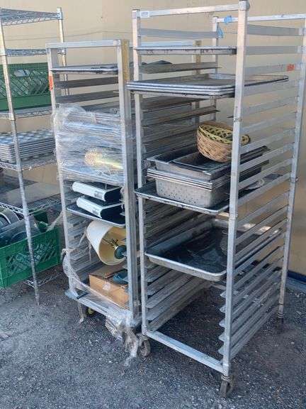 Two aluminum sheet pan racks with assorted restaurant equipment ...
