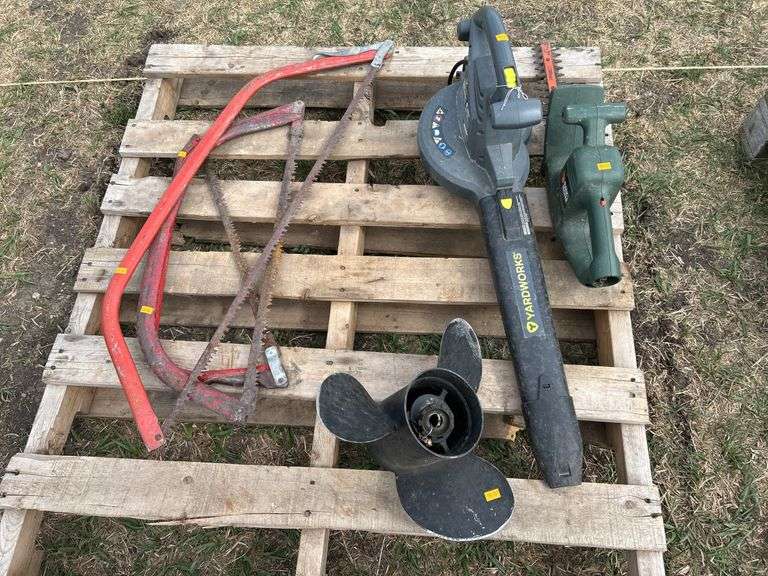 Pallet of buck saw, electric blower, electric trimmer, and boat prop ...