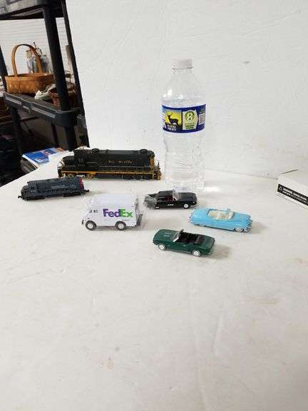 Small Car Figures And Two Train Engines - Trice Auctions