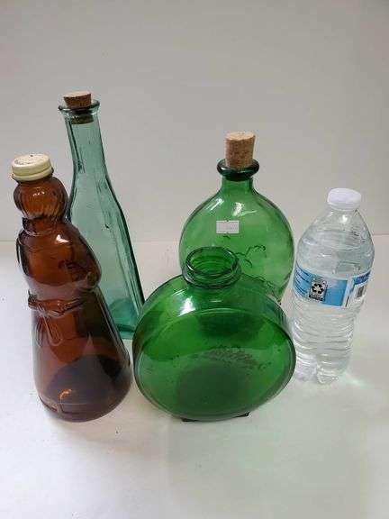 Collection of Four Decorative Glass Bottles in Various Shapes and Sizes ...