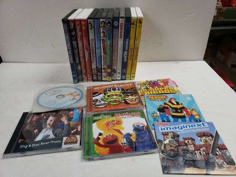 Collection of DVDs and CD Albums Featuring Movies, Cartoons, and Music ...